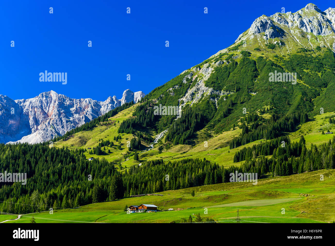 Beautiful alpine summer landscape. Mountains and sun, blue sky, calm ...
