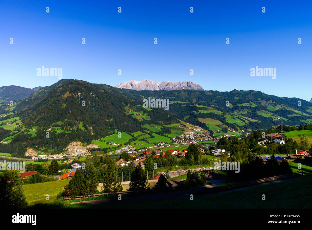Beautiful alpine summer landscape. Mountains and sun, blue sky, calm ...