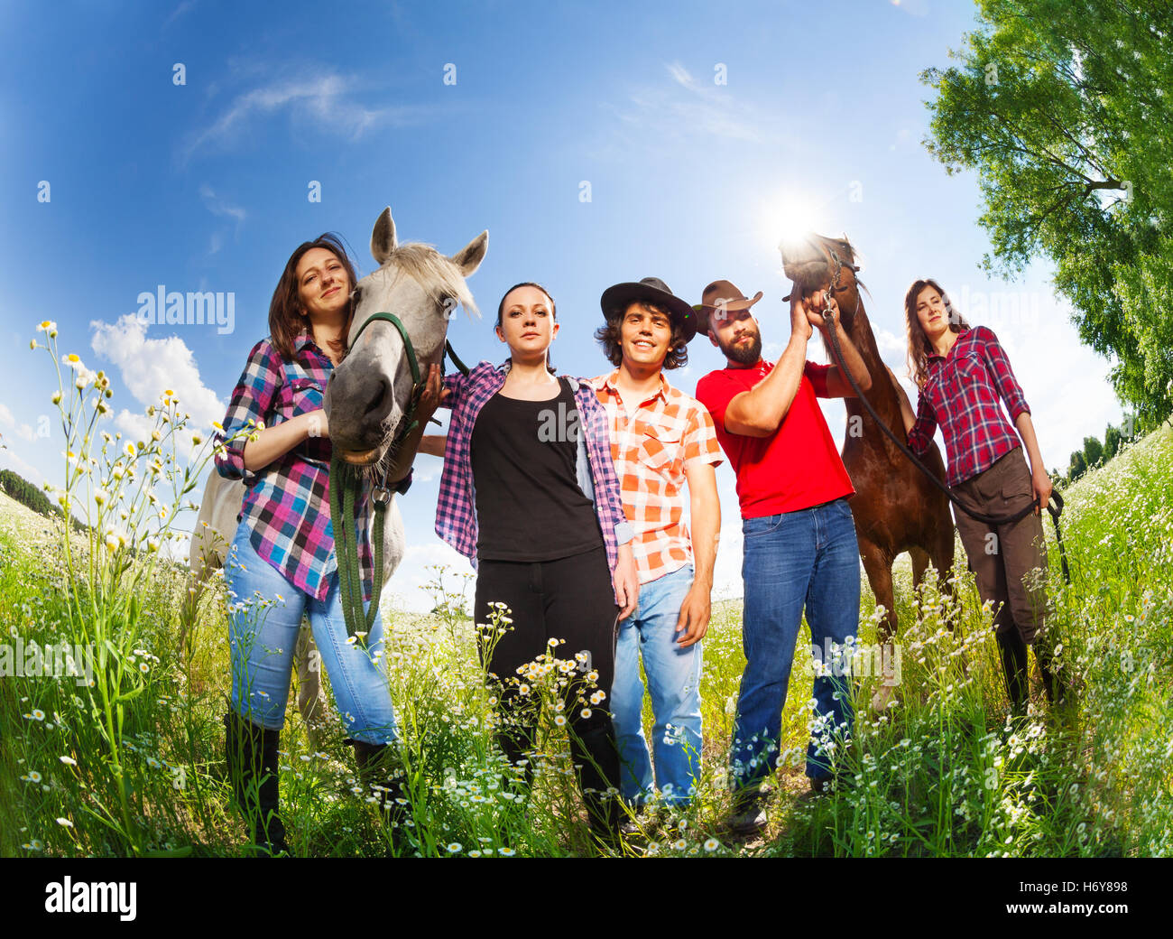 Portrait of happy horseback riders with two horses Stock Photo - Alamy