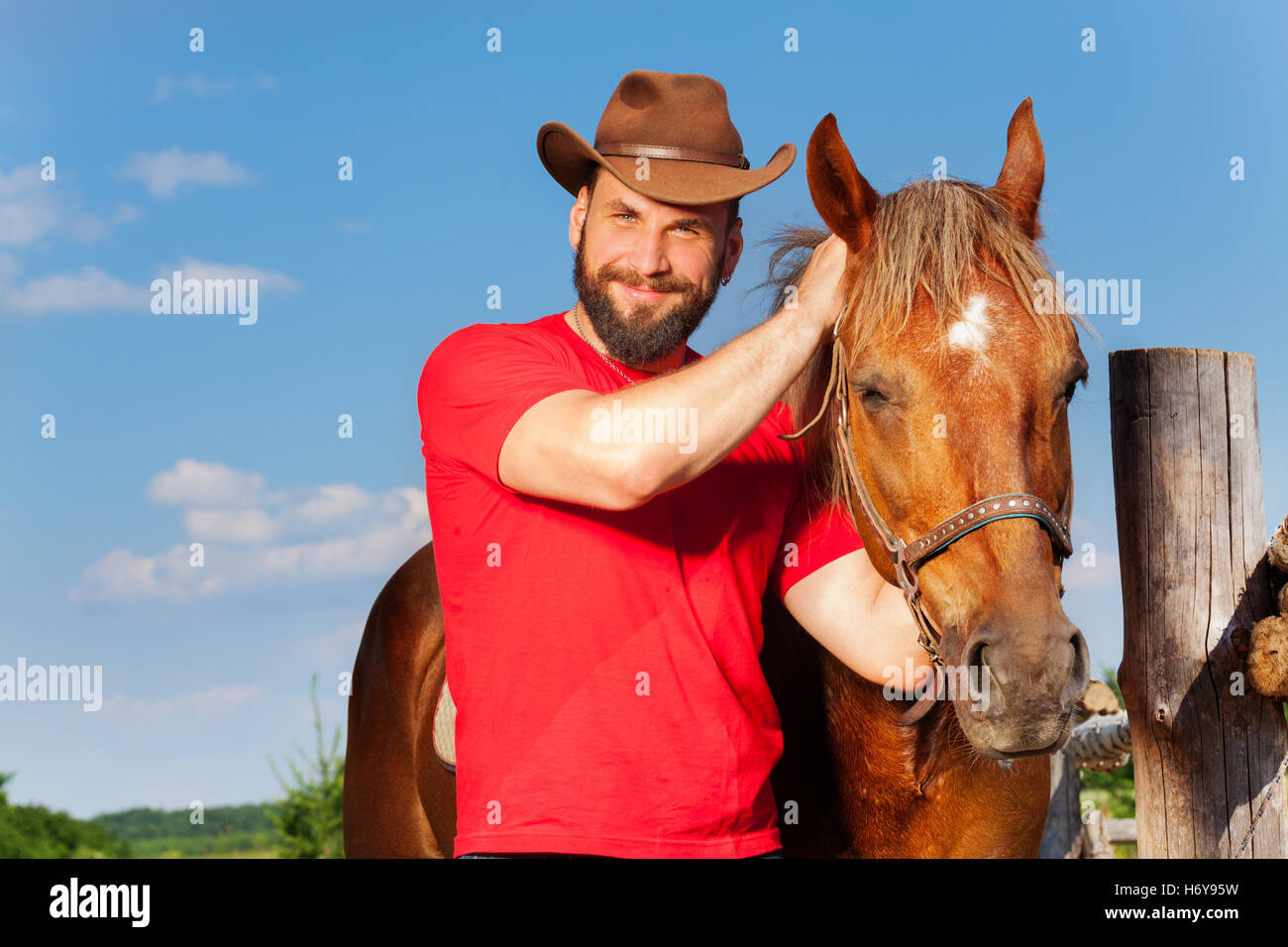 Portrait of smiling cowboy with his bay horse Stock Photo - Alamy