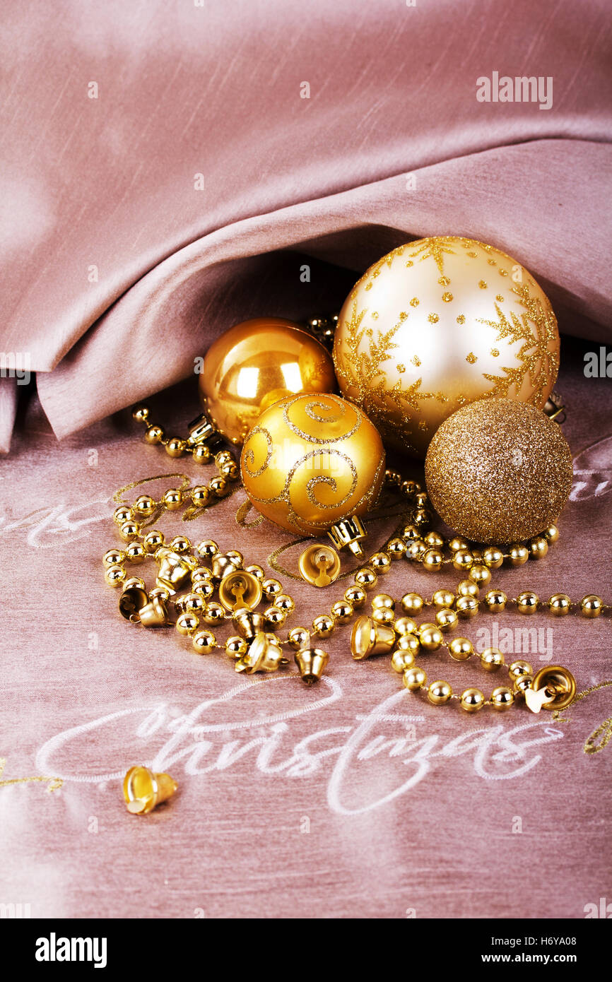 Festive gold Christmas decorations on a fabric background Stock Photo ...