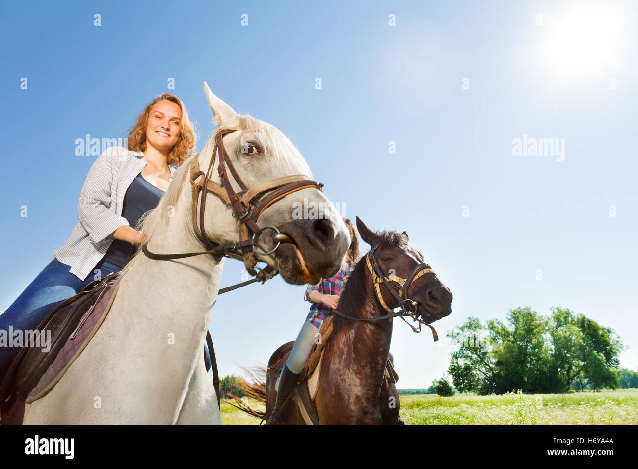 Happy female equestrians riding beautiful horses Stock Photo - Alamy