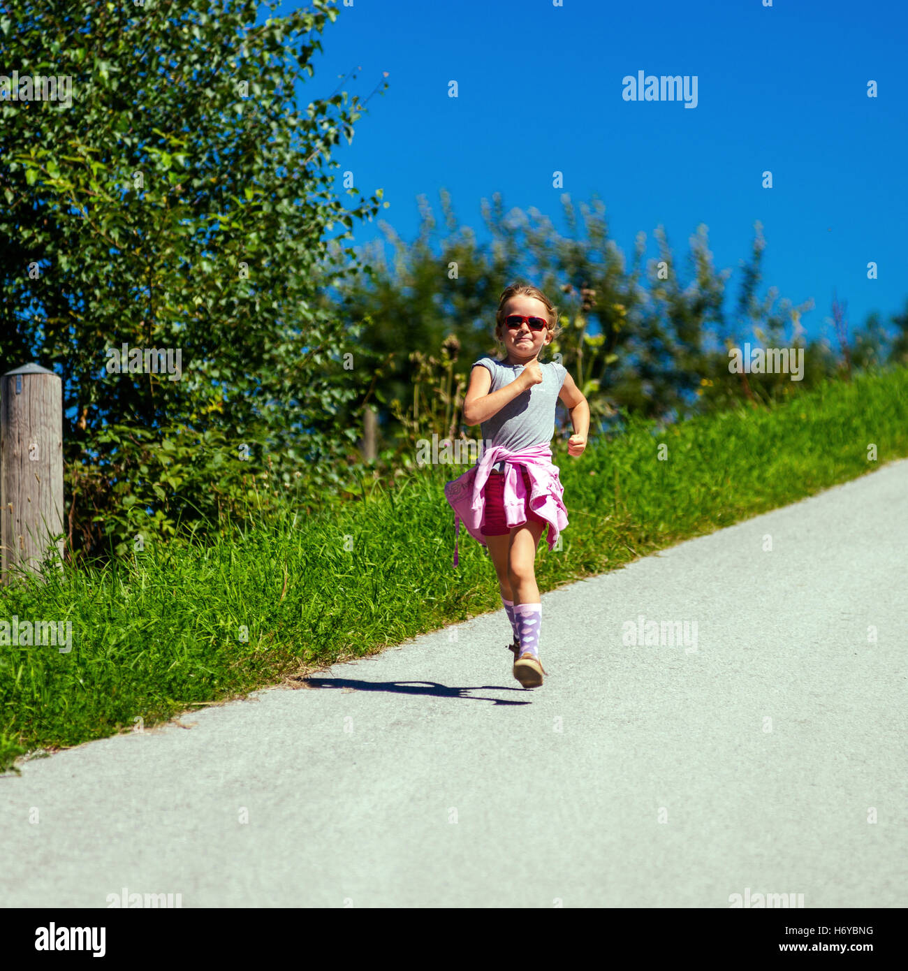 Cute little girl running on the road, energy of youth concept Stock ...