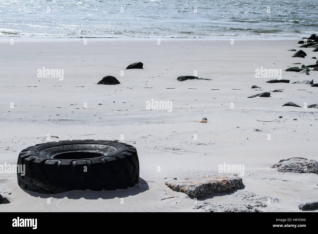 A tire sits on the beach Stock Photo - Alamy