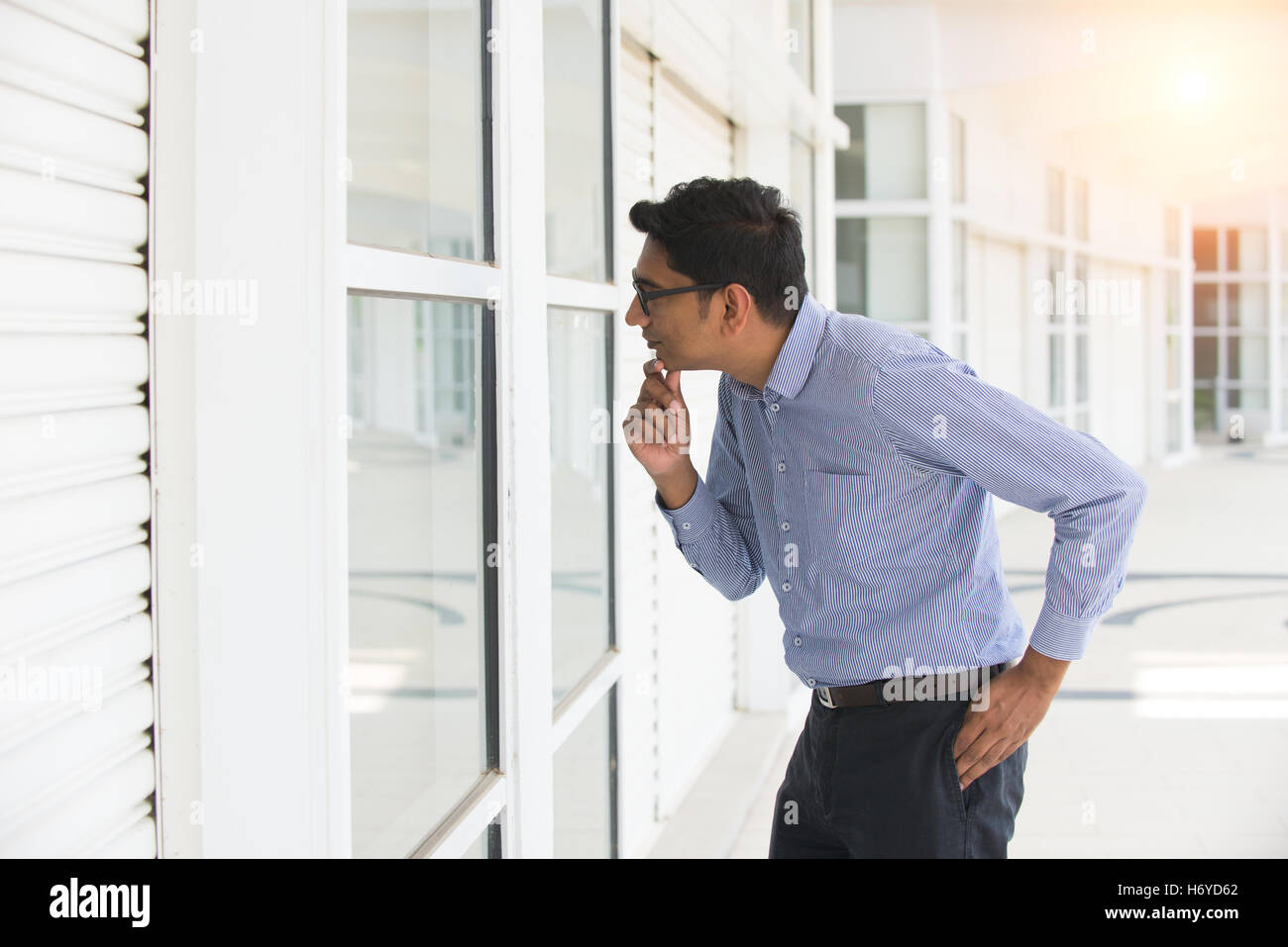 Male real estate agent looking up at a house exterior Stock Photo - Alamy