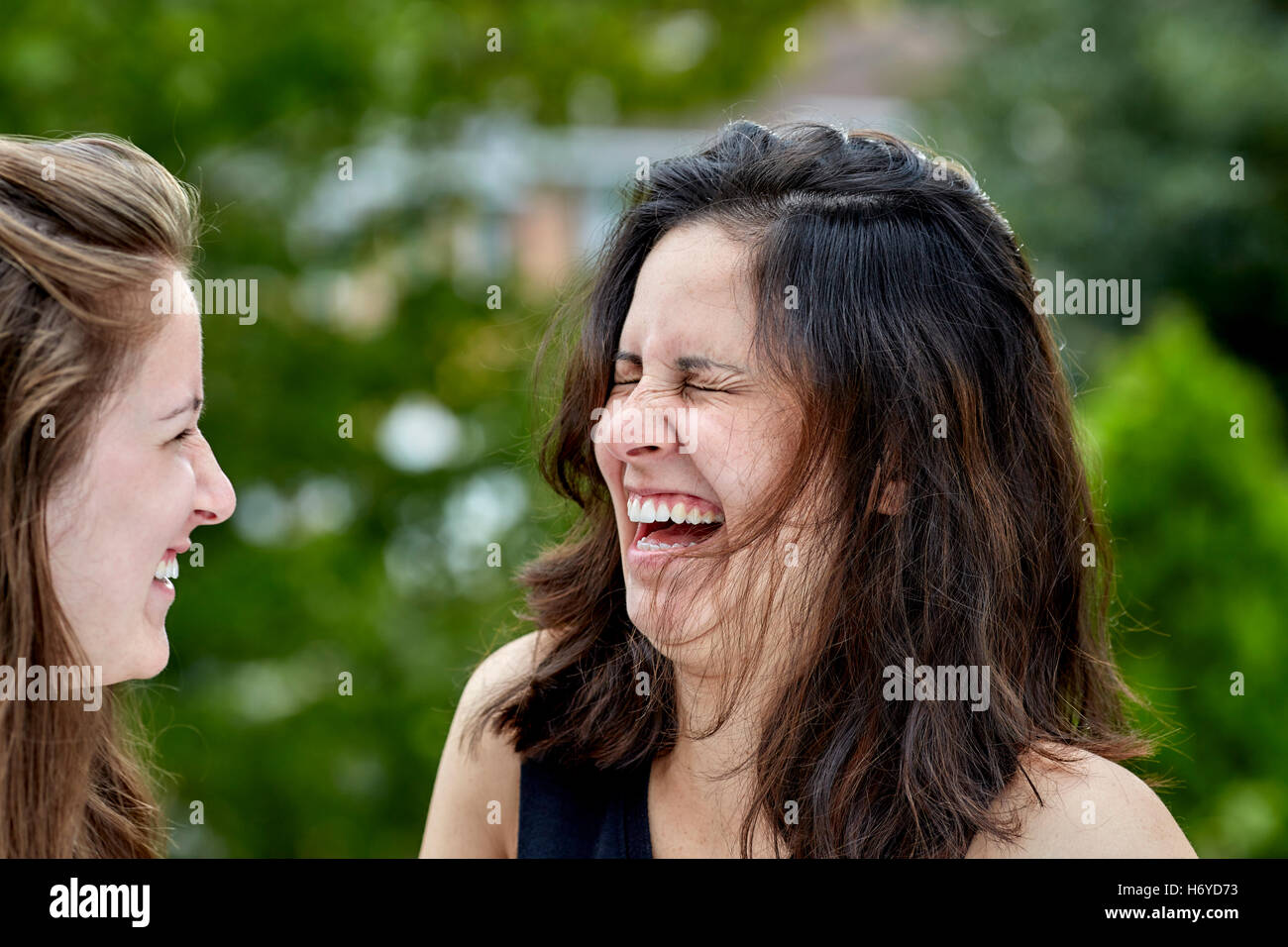 Close Up of two friends laughing out loud Stock Photo - Alamy