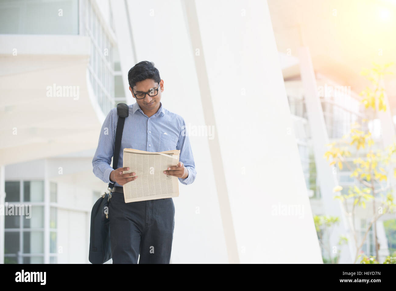 young indian male reading newspaper with copyspace Stock Photo - Alamy