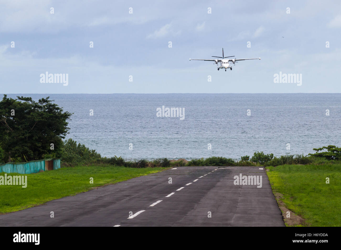 small local flight landing on a small paved runway with the pacific ...