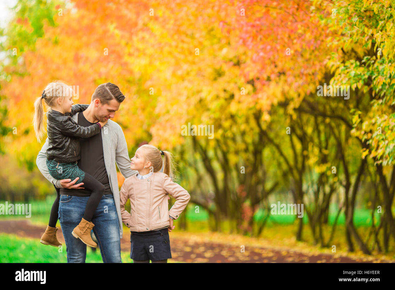 Family having fun on autumn day. Dad and kids enjoy fall Stock Photo ...