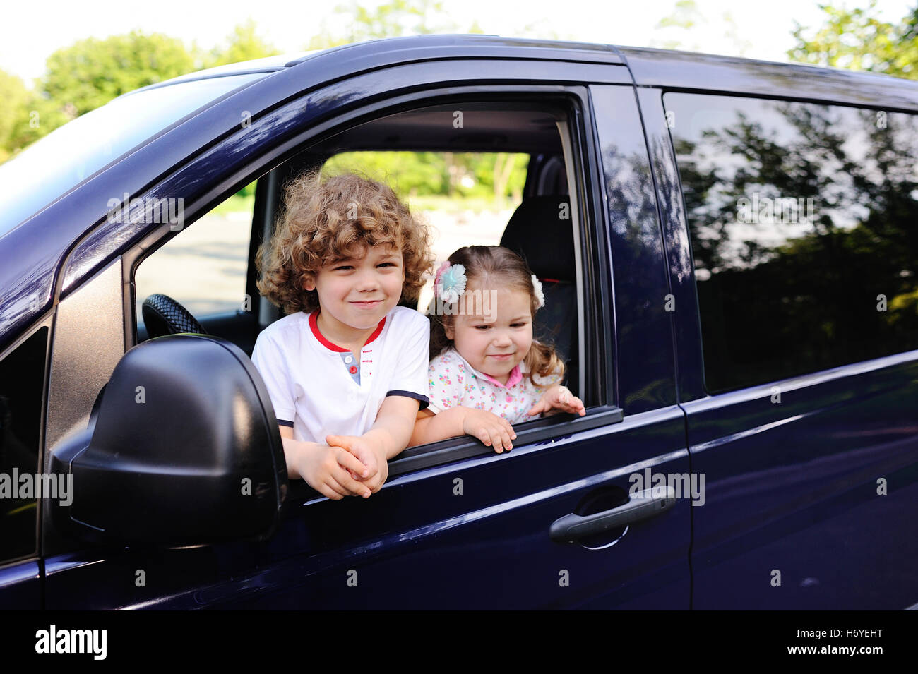 children look out from a car window Stock Photo - Alamy