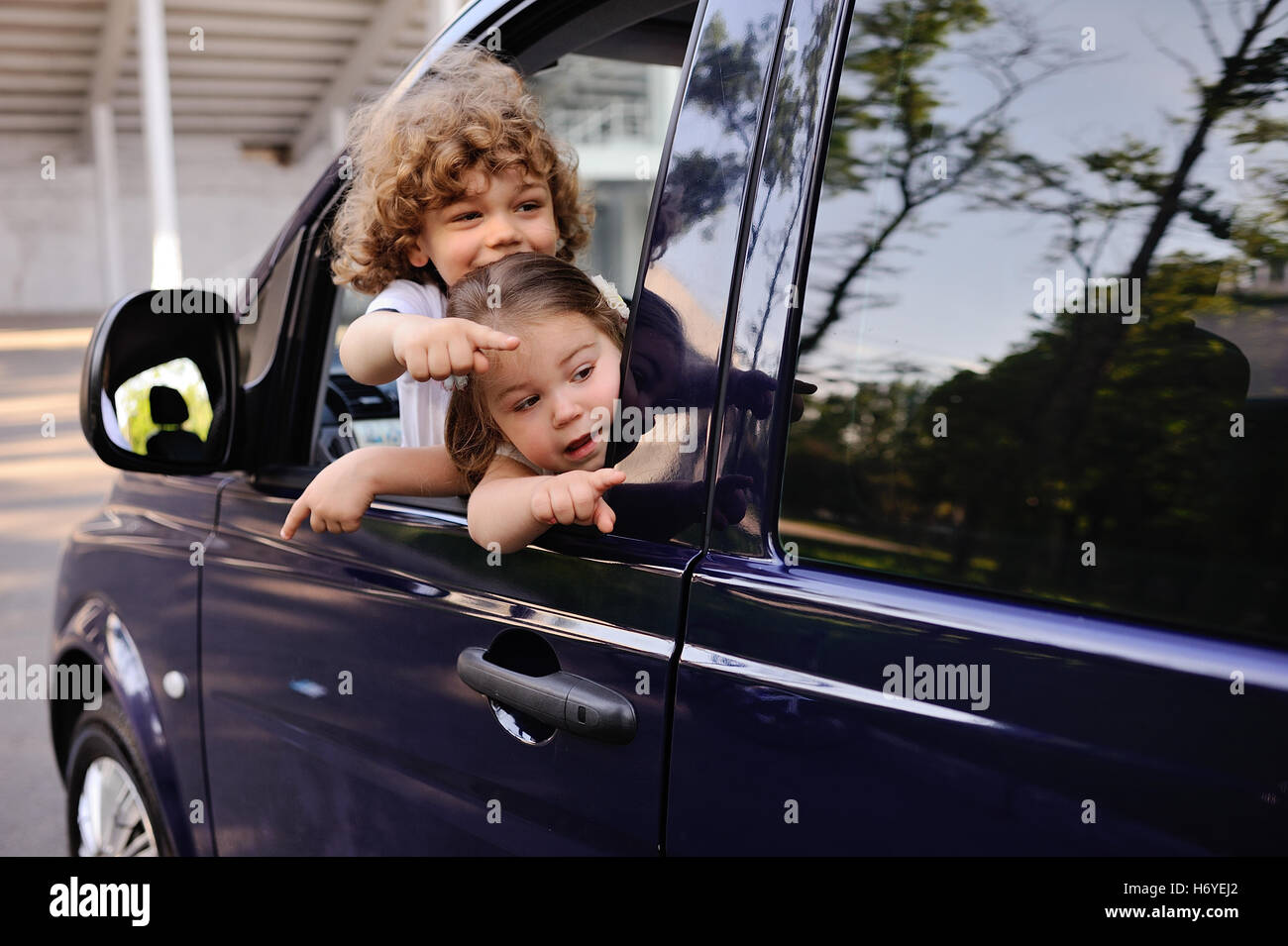 children look out from a car window Stock Photo - Alamy