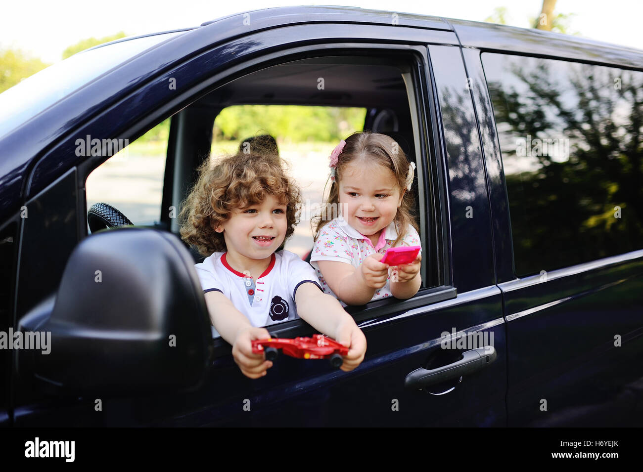 children look out from a car window Stock Photo - Alamy