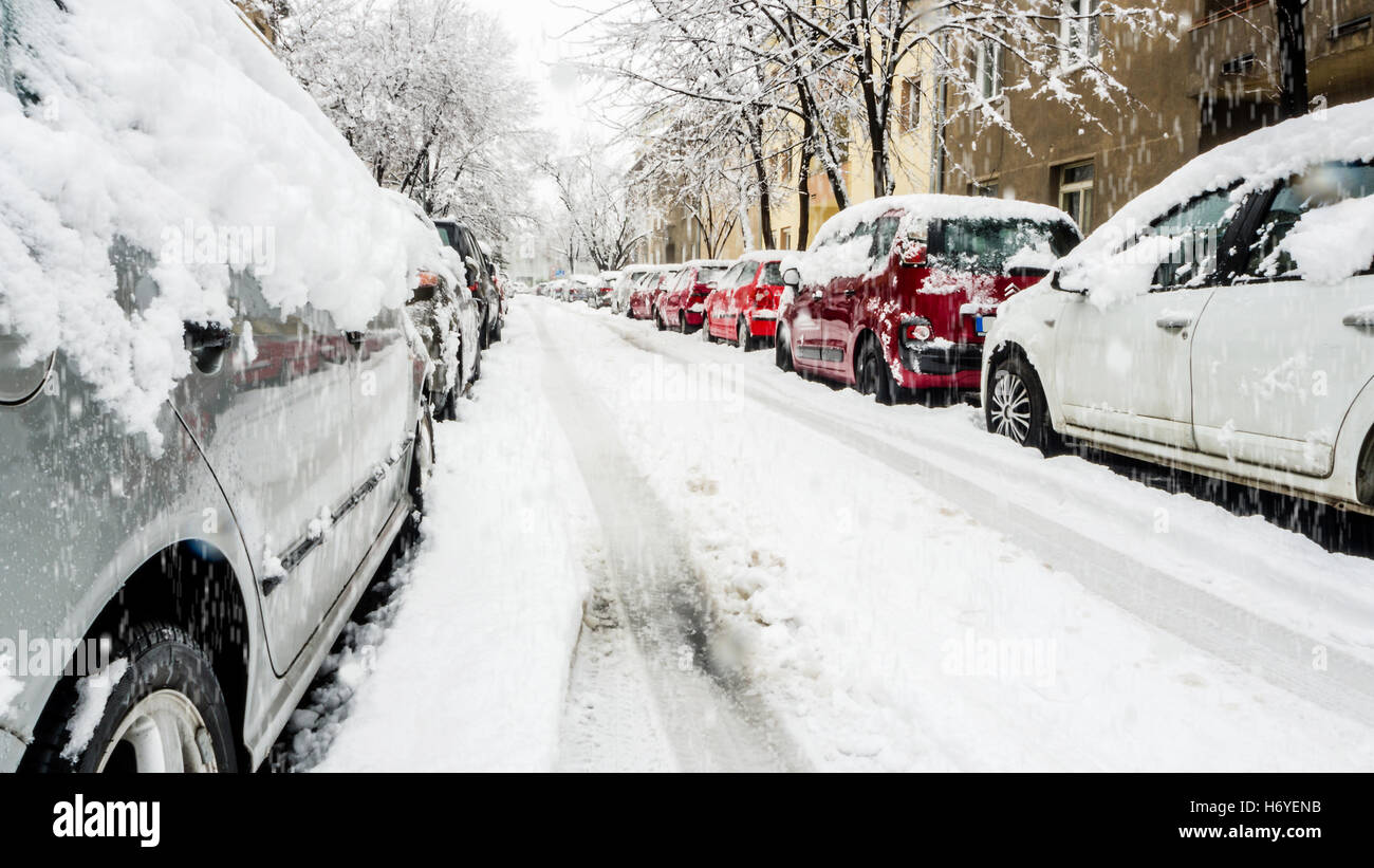 city street covered with snow during heavy winter storm in one European ...