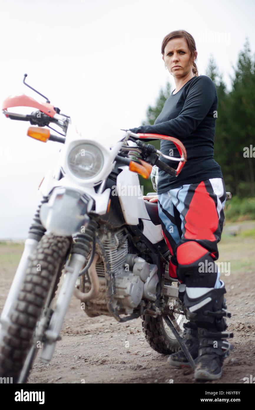 Portrait of young adult female motorcyclist with motorcycle Image ...