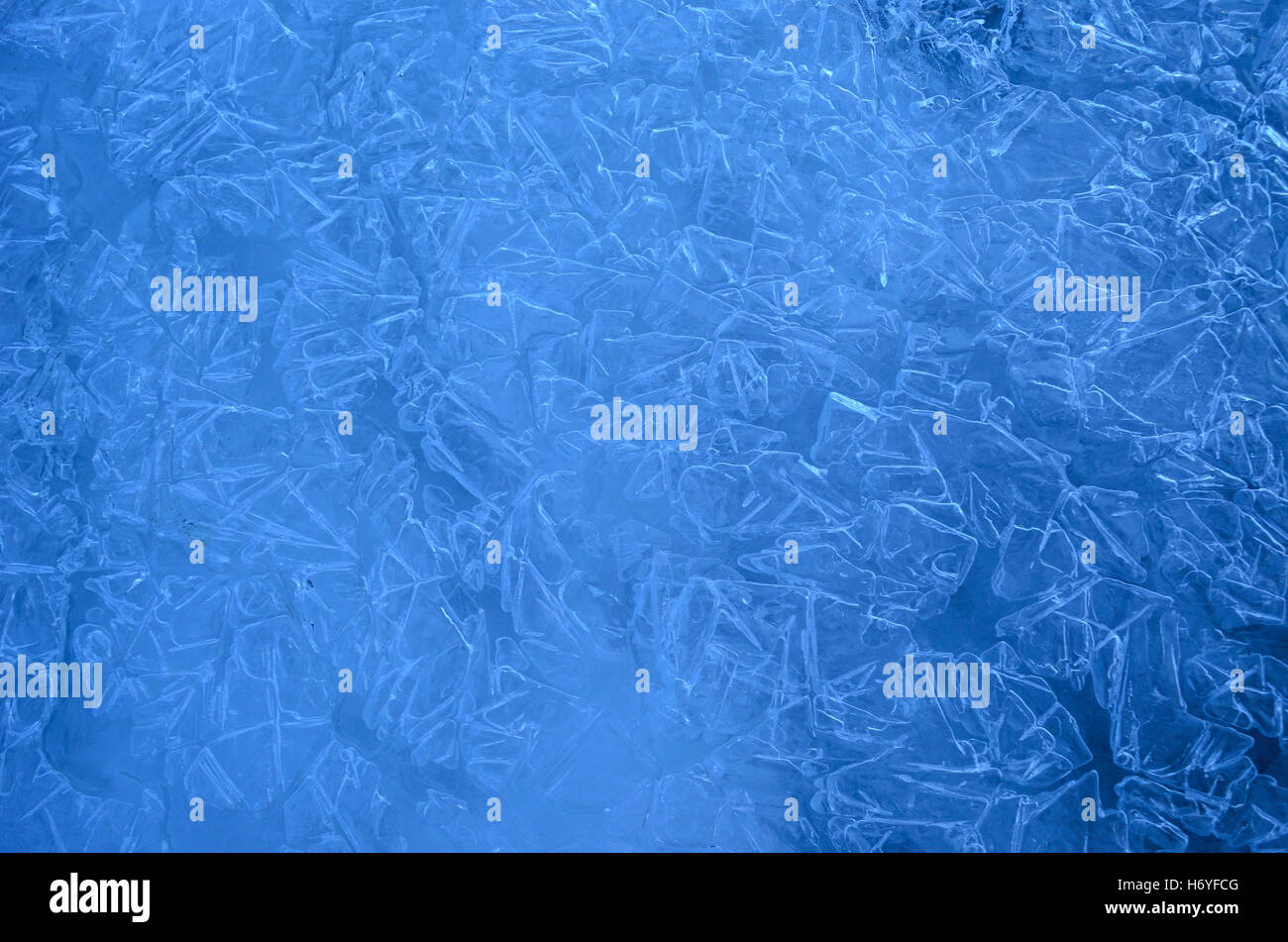 beautiful shapes on blue river ice background Stock Photo - Alamy