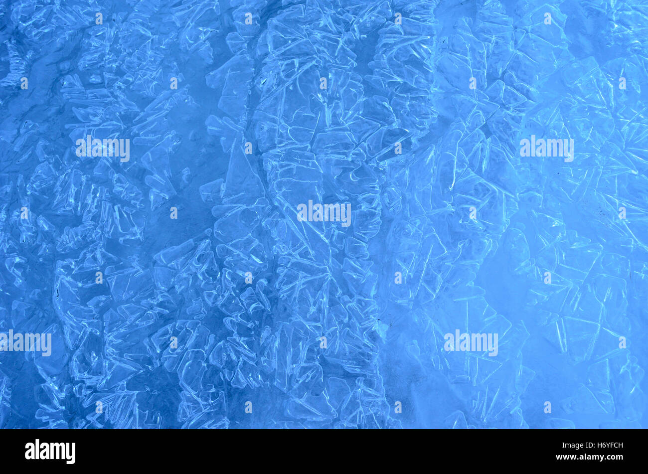 beautiful shapes on blue river ice background Stock Photo - Alamy