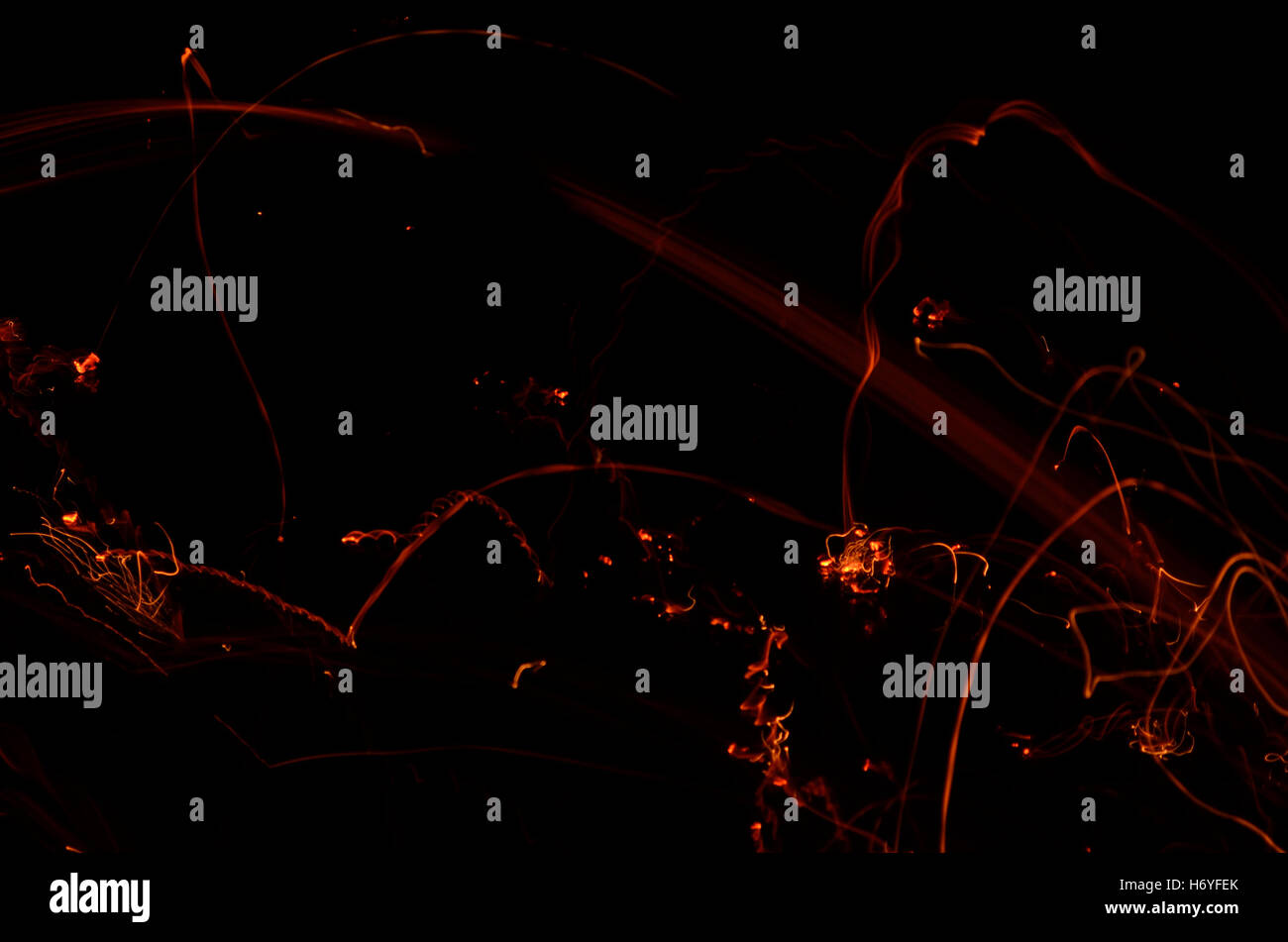 fiery embers falling in darkness background Stock Photo - Alamy