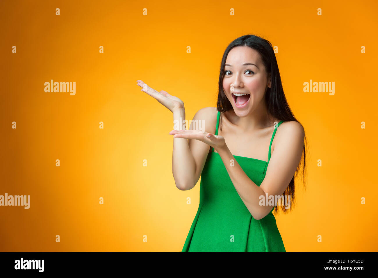The happy Chinese girl on yellow background Stock Photo - Alamy