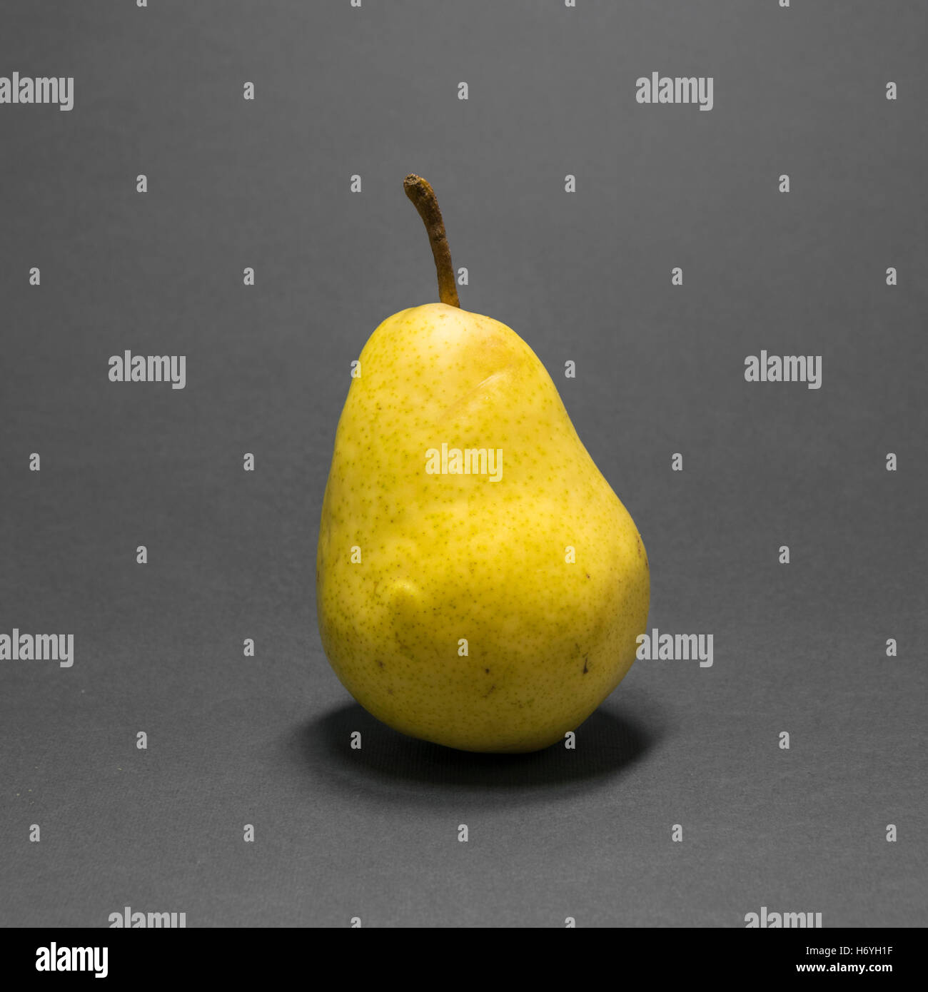 Yellow ripe pear on a gray gradient background Stock Photo - Alamy
