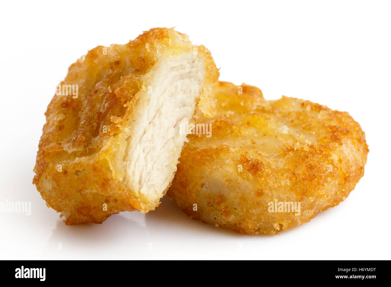 Two golden deep-fried battered chicken nuggets isolated on white in ...