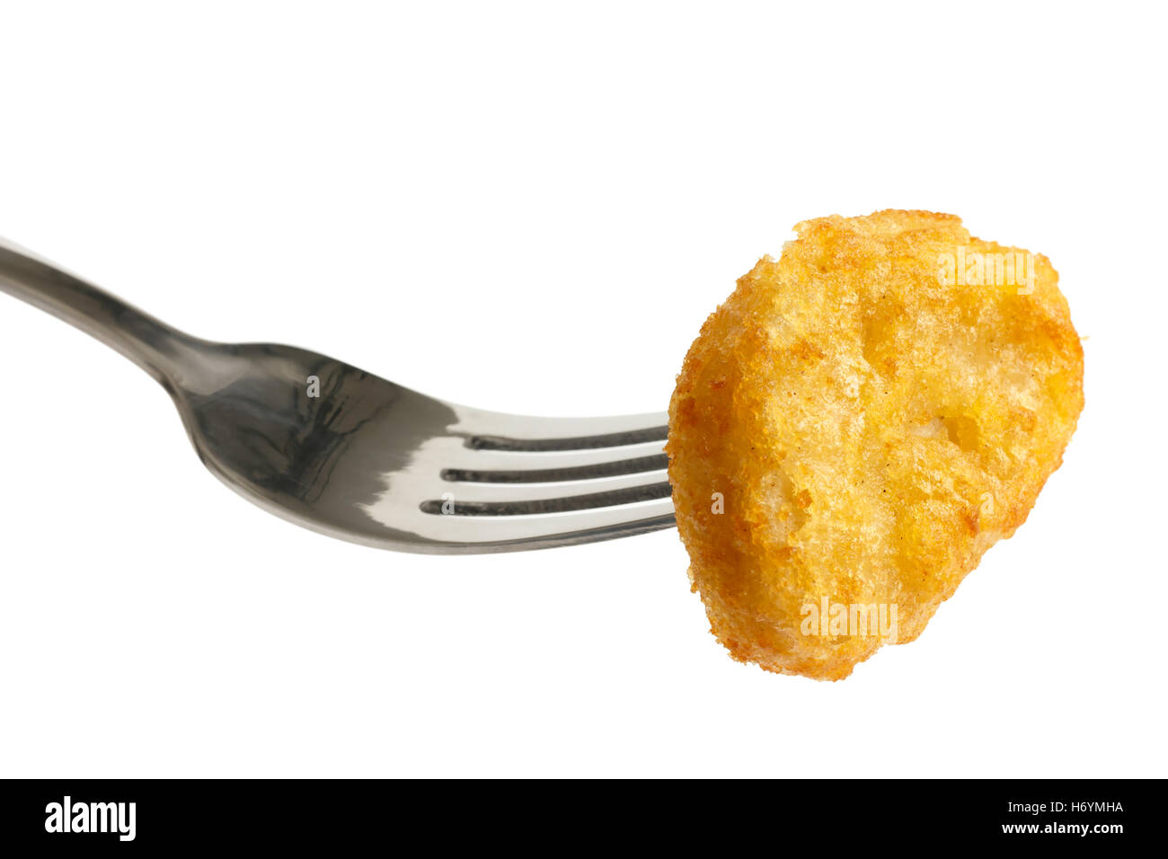Single golden deep-fried battered chicken nugget on a fork isolated on ...