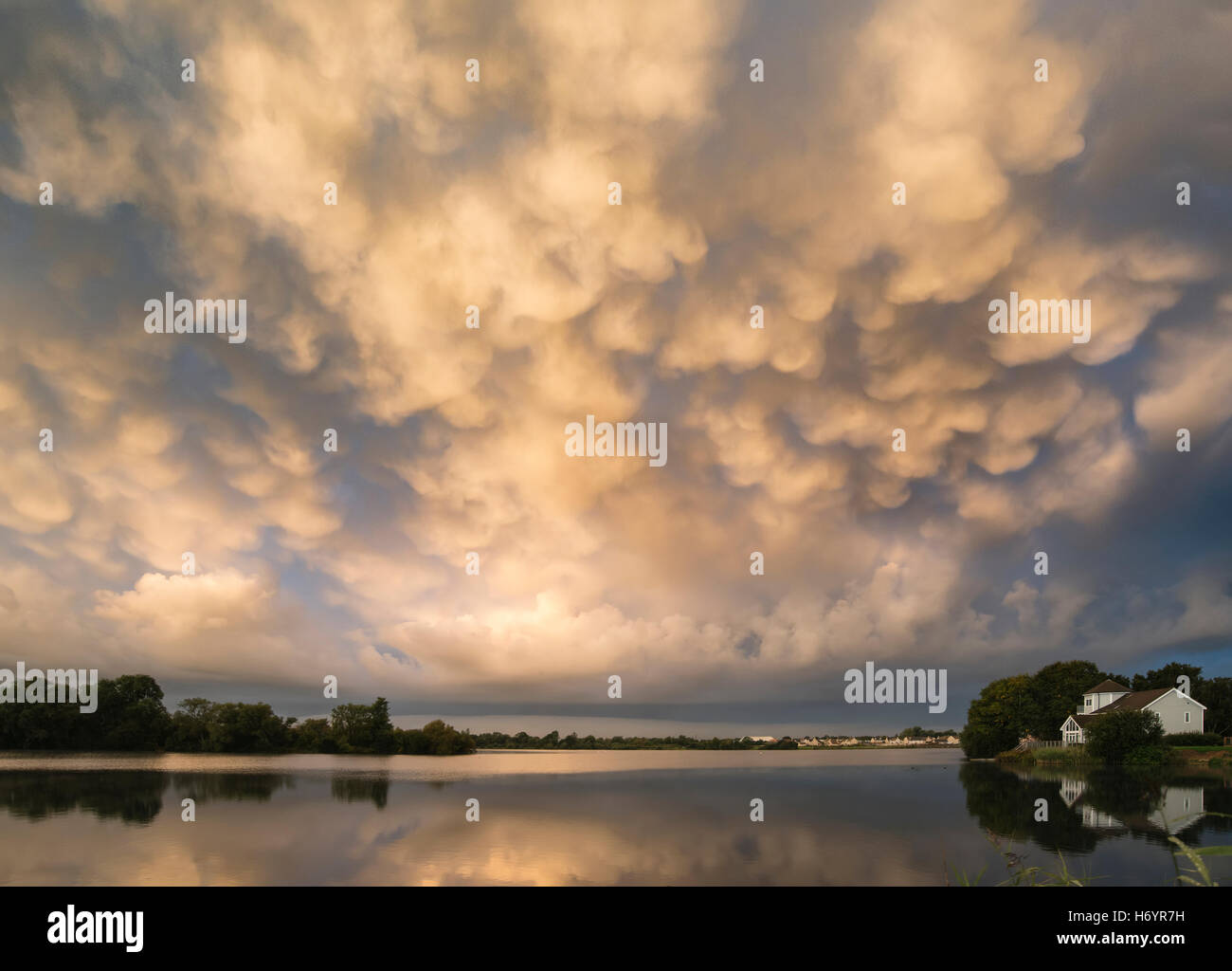 Stunning mammatus clouds formation over lake landscape immediately ...