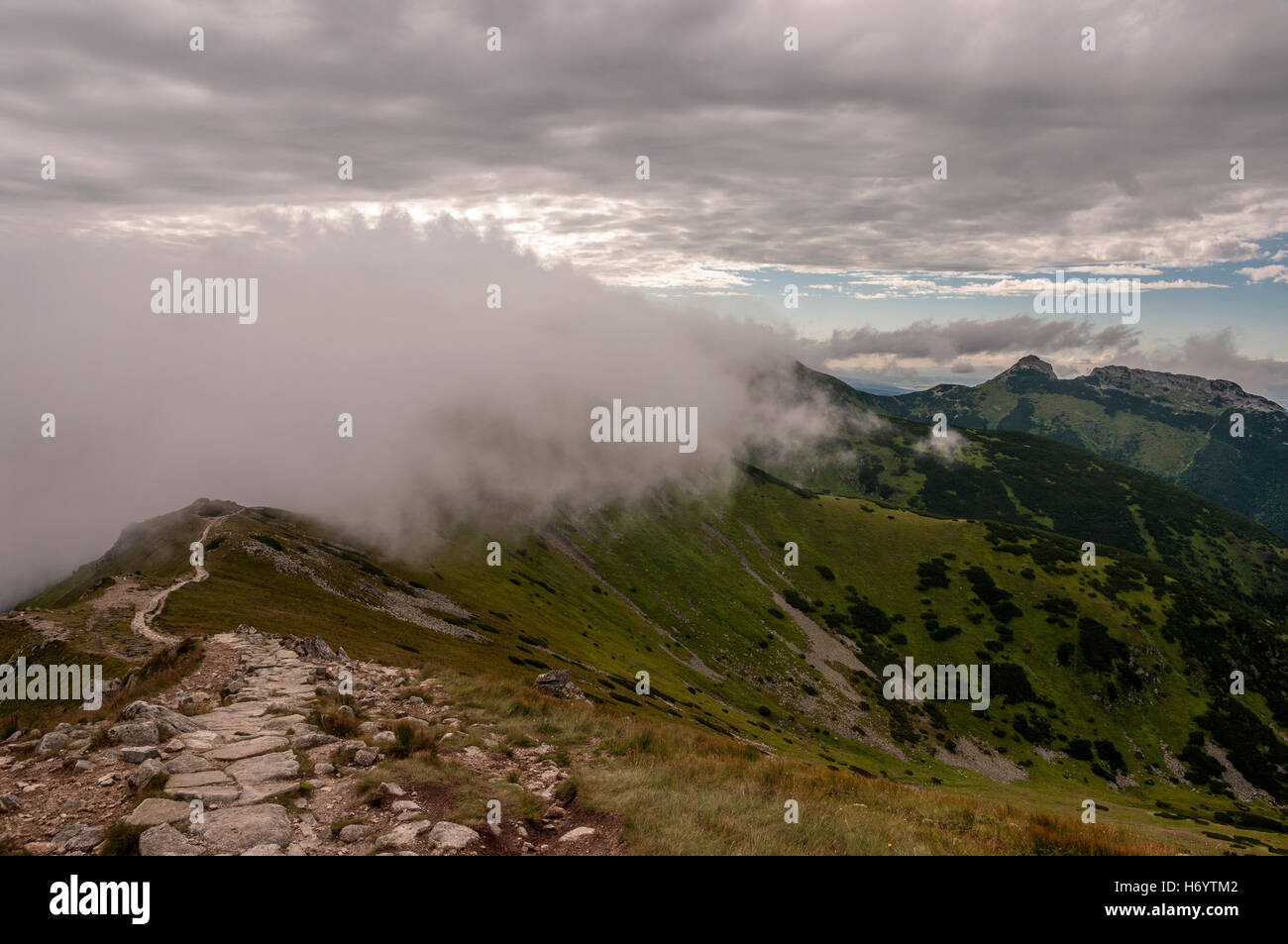 Amazing view of the mountain ridge under the clouds Stock Photo - Alamy