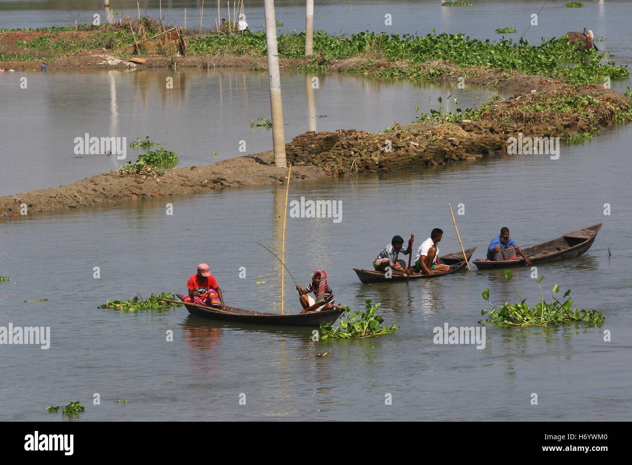 Seasonal fishermen busy fishing in the Turag river at Savar outside the ...