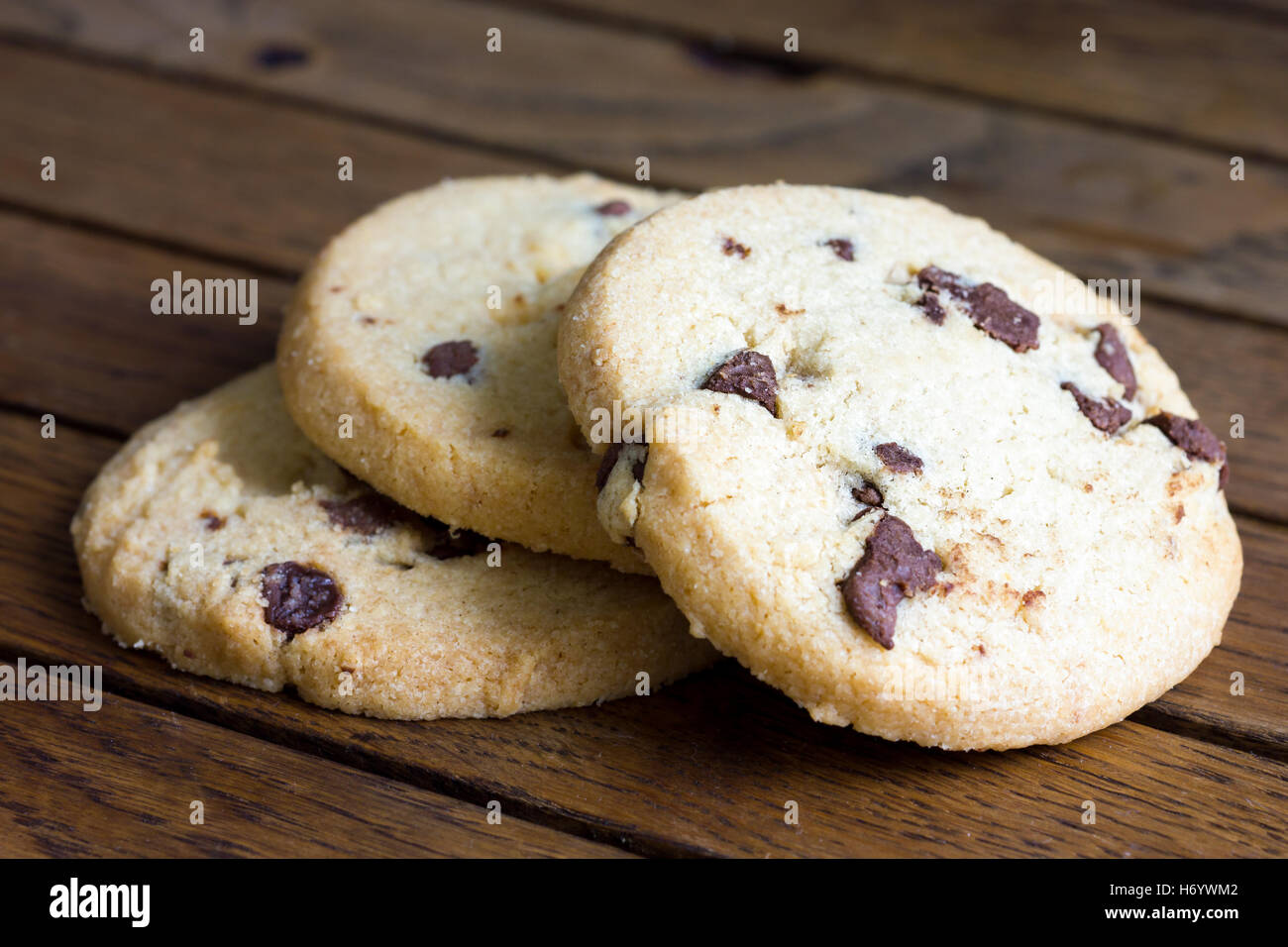Round chocolate chip shortbread biscuits. On rustic wood Stock Photo ...