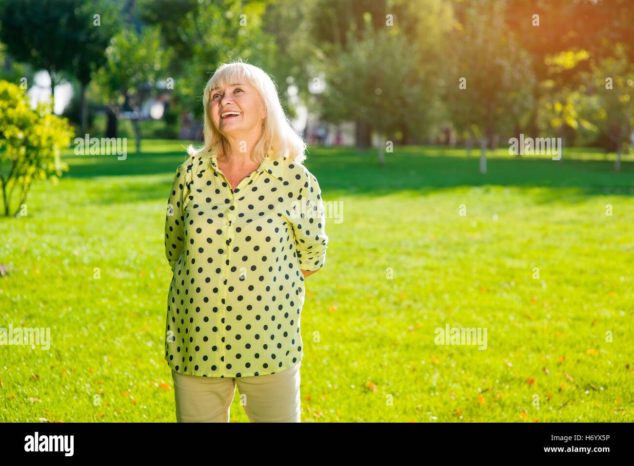 Senior woman standing and smiling Stock Photo - Alamy