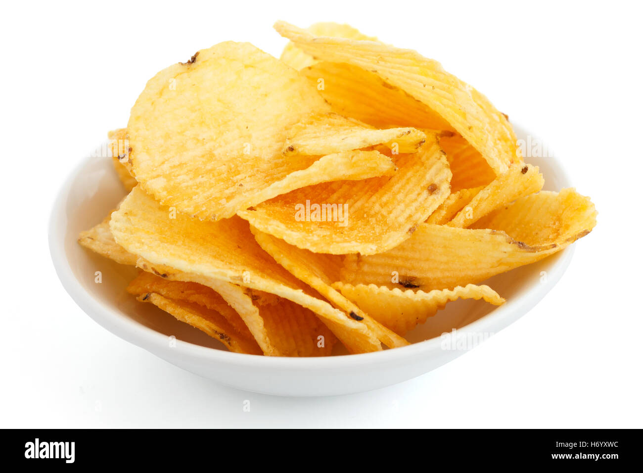 Crinkle cut crisps in a white bowl on white background Stock Photo - Alamy