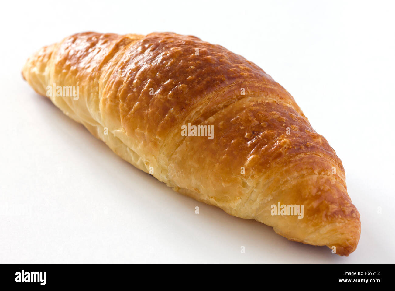 Single croissant on white surface Stock Photo - Alamy