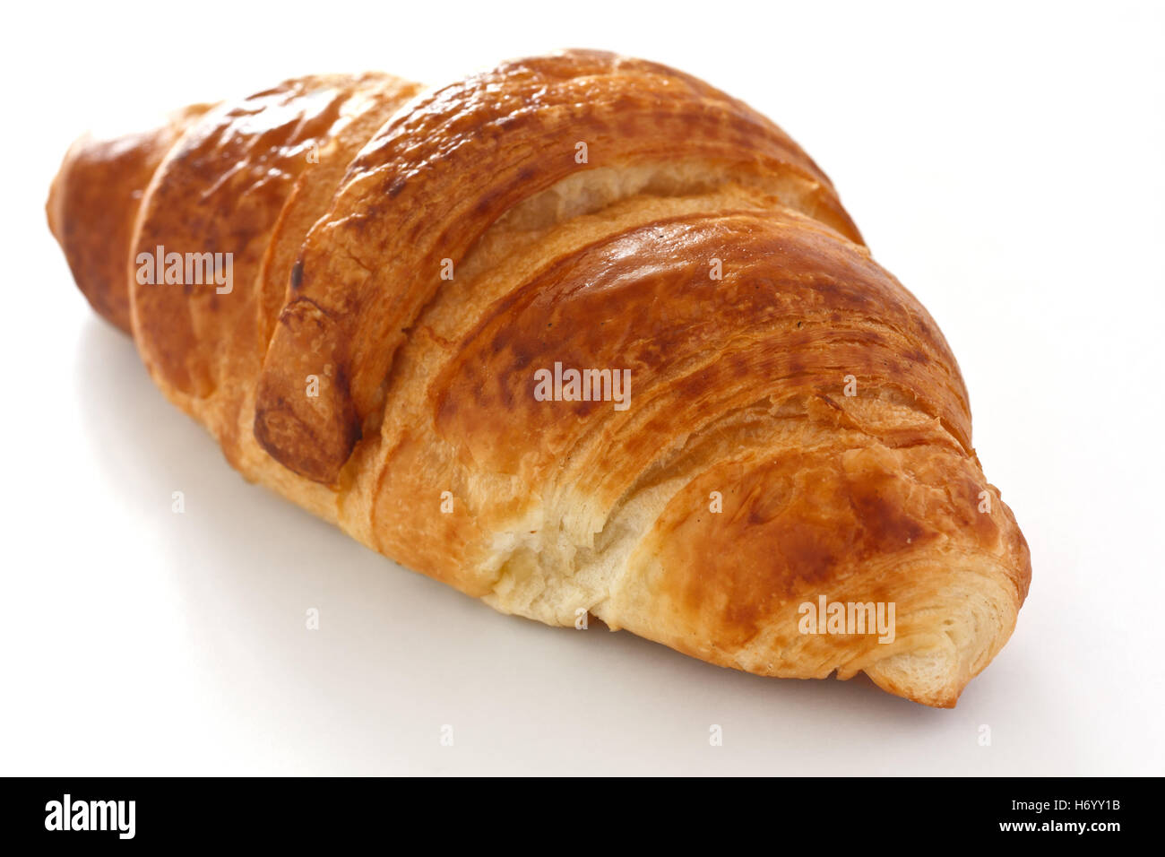 Single crispy croissant on white surface Stock Photo - Alamy