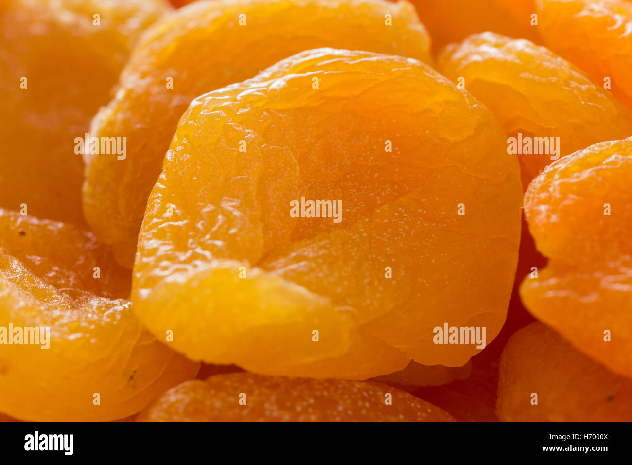 Whole dried apricots macro background Stock Photo - Alamy