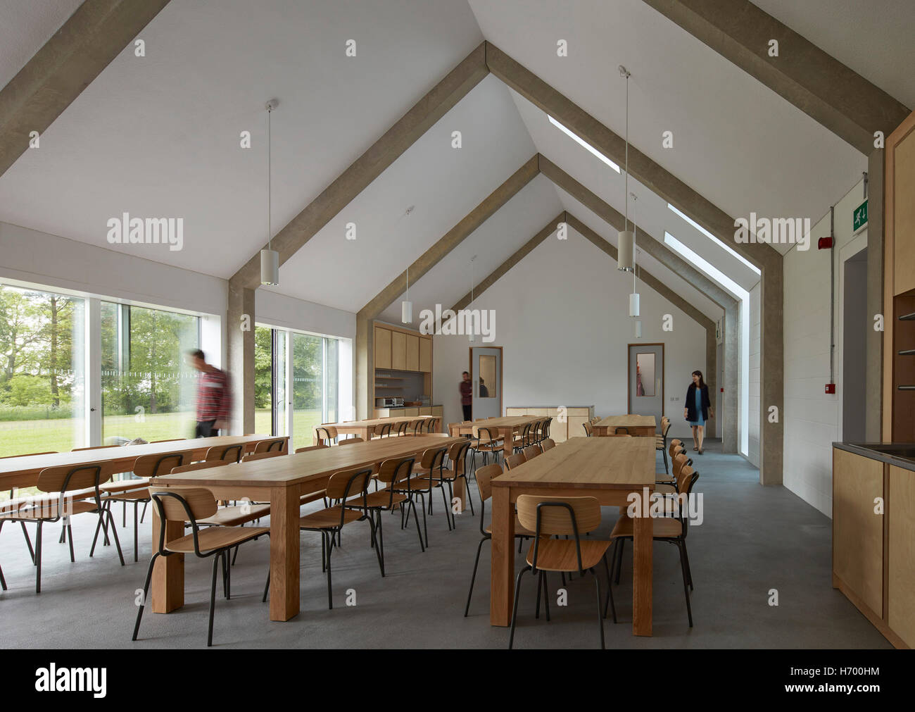 Communal dining room with exposed concrete ribcage. Vajrasana Retreat ...