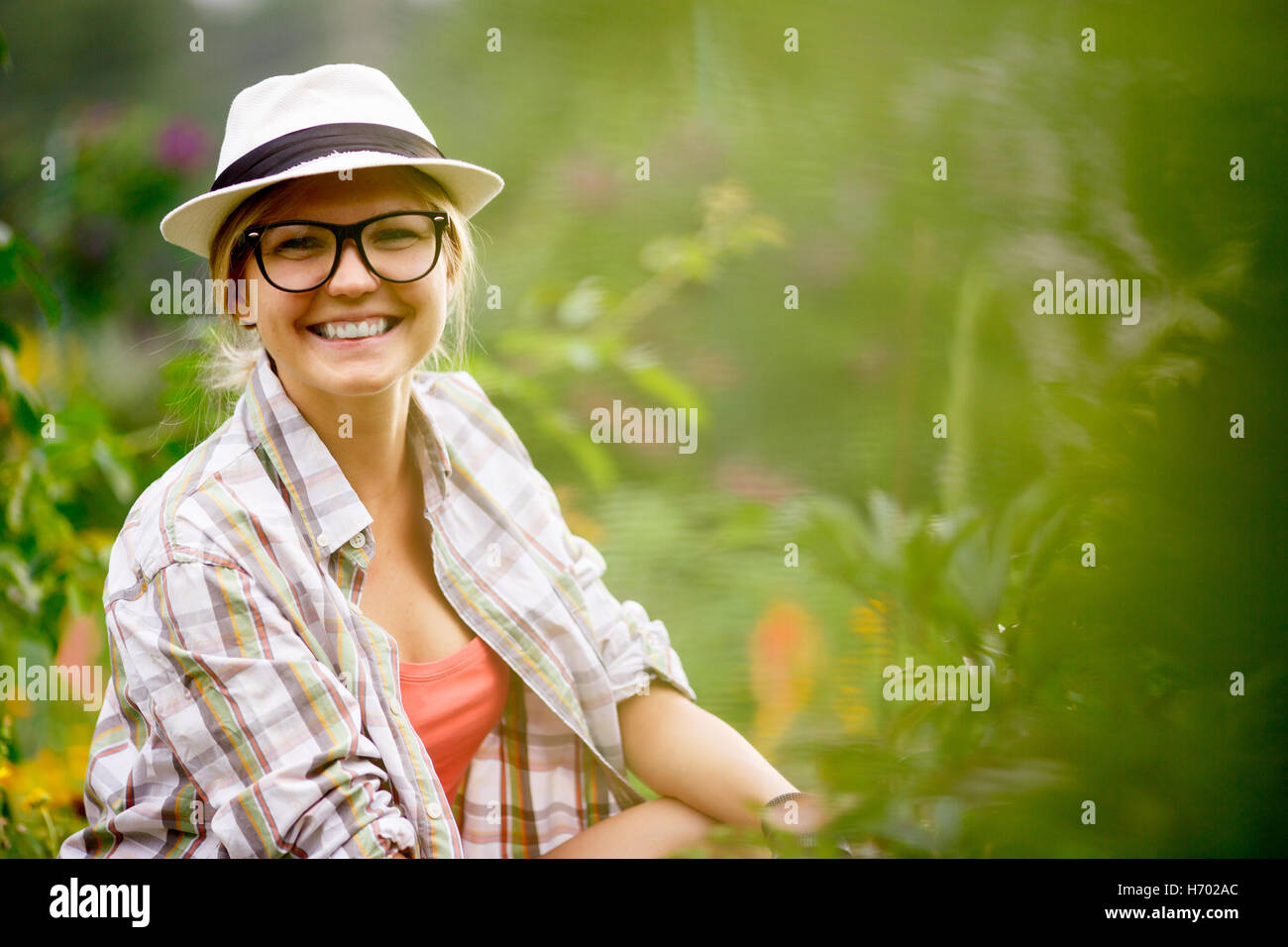 Portrait of female gardener among the plants in summer season Stock ...