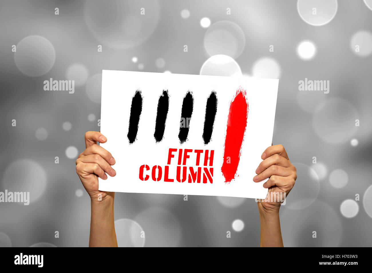 FIFTH COLUMN card in hand with abstract light background. Selective ...