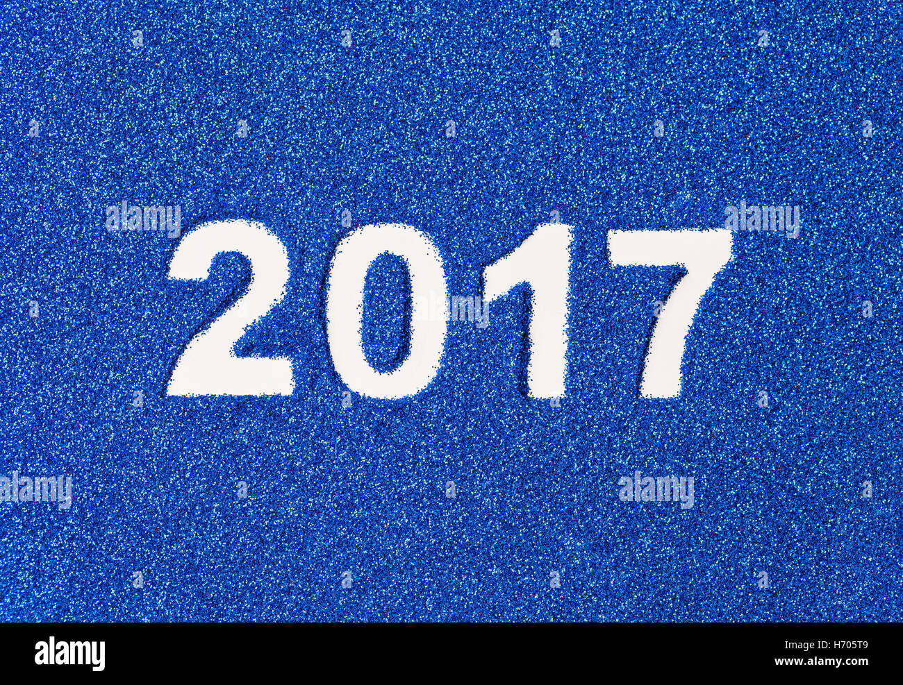 New Year Numbers 2017 written on a background of blue glittering ...