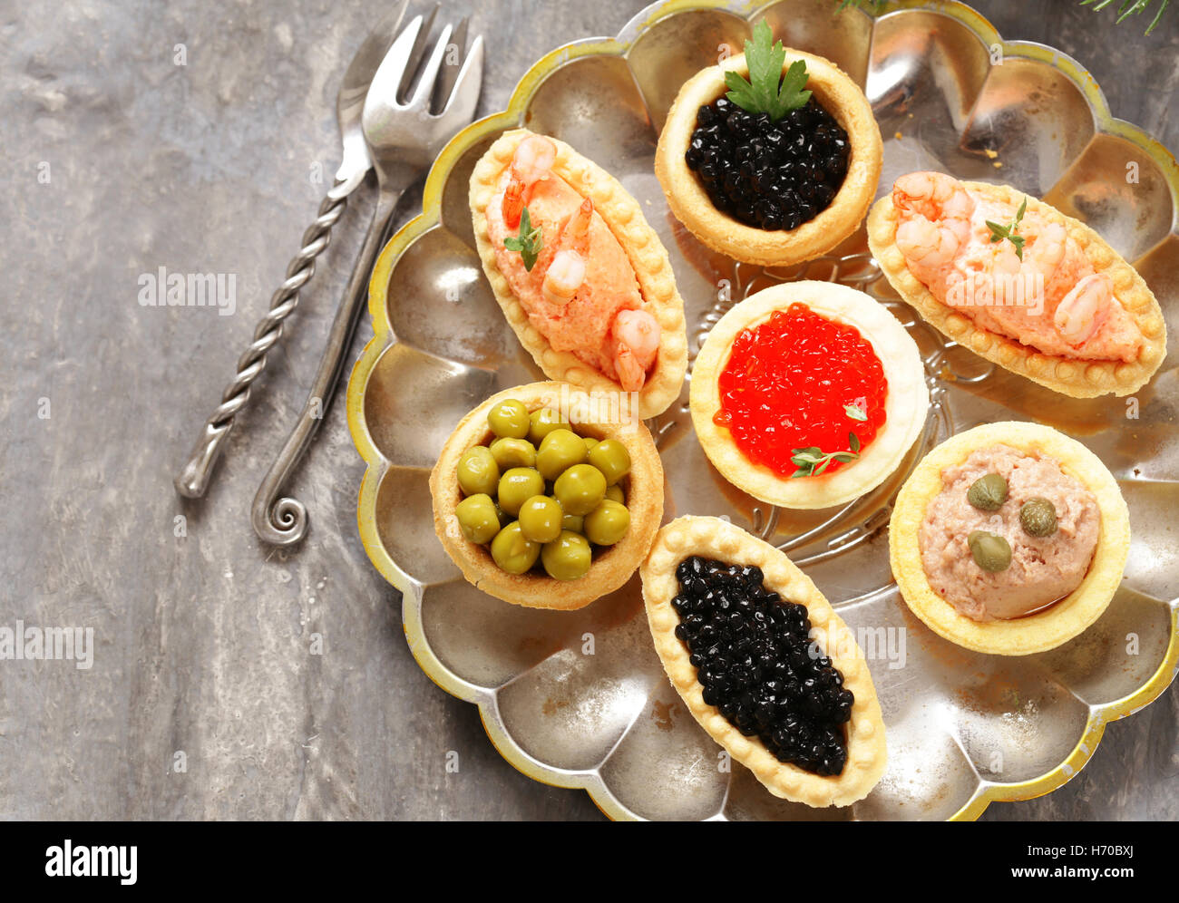 Christmas appetizers. Small tartlets with caviar and pate. Buffet and ...