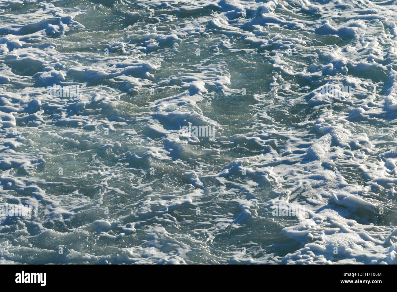 Stormy sea water surface with white foam over waves pattern, natural ...
