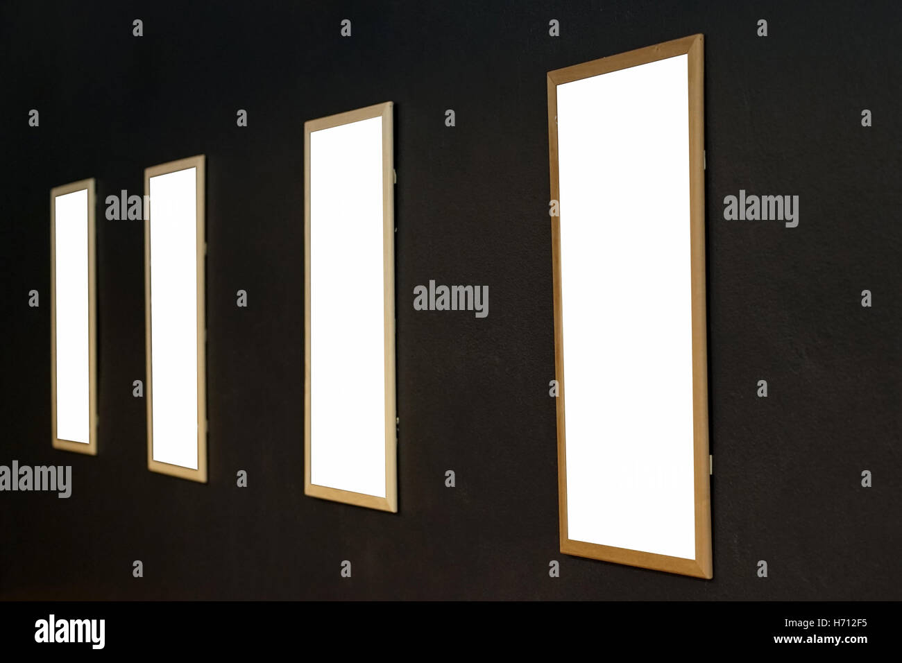 wooden empty picture frames on black wall Stock Photo - Alamy