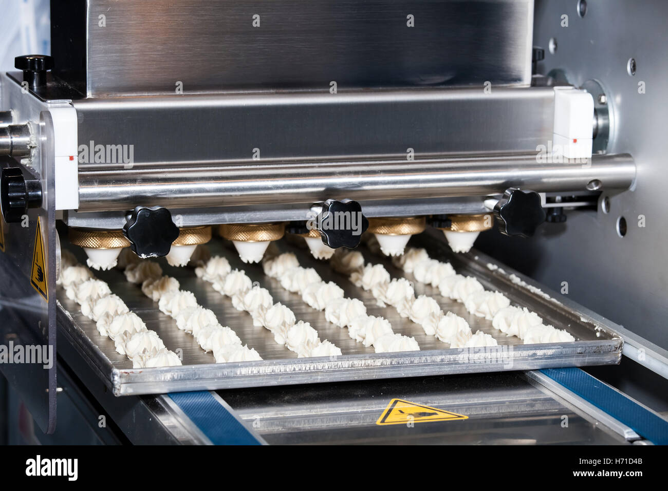 Biscuit depositing machine Stock Photo - Alamy