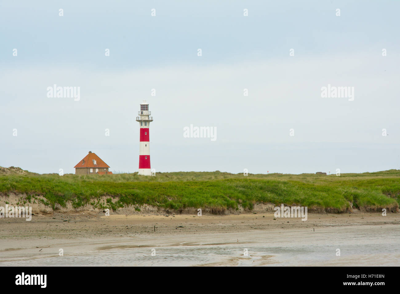 Lighthouse and house in the Dunes next to Yser river, Nieuwpoort ...
