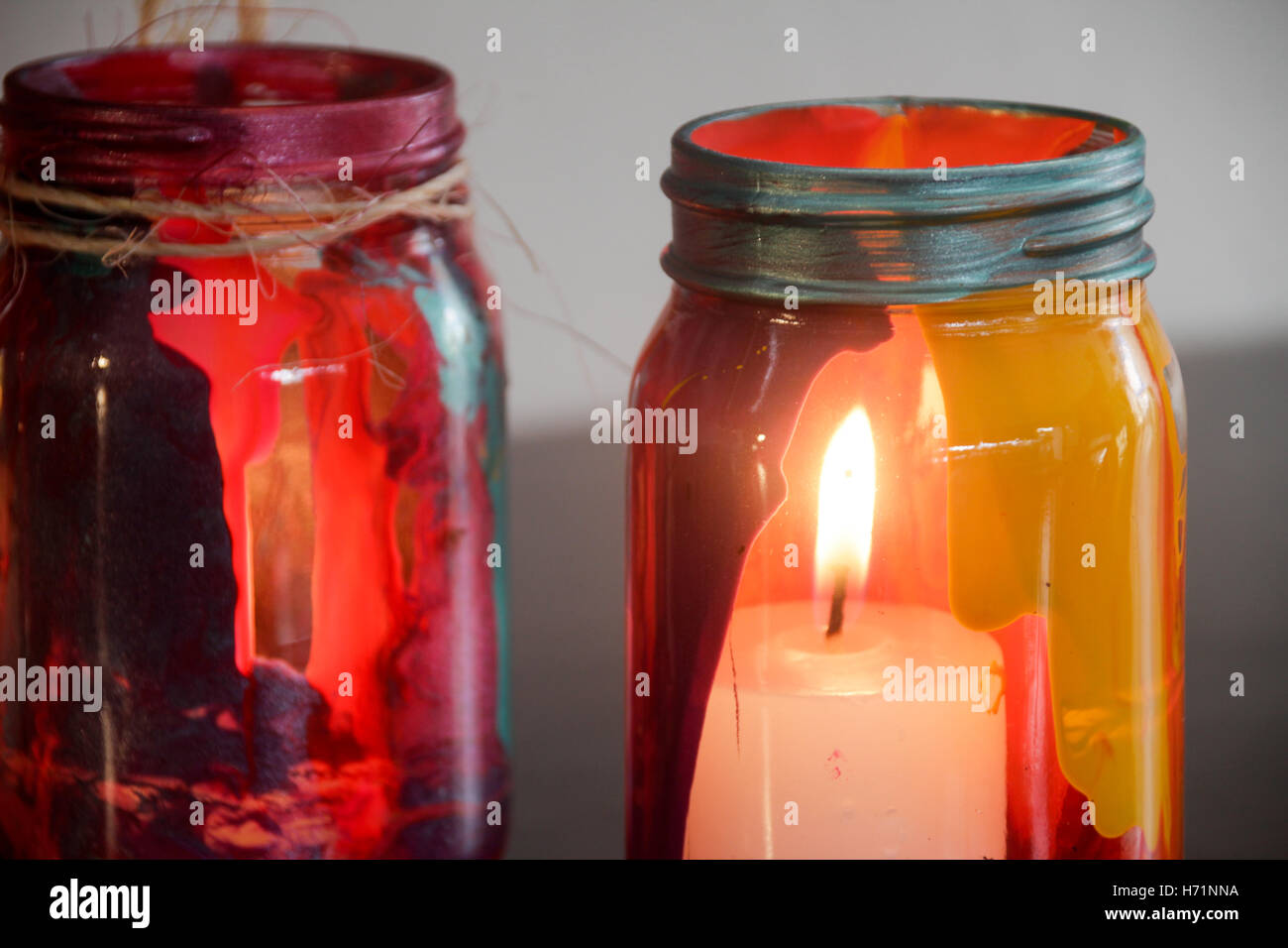 Photograph of some colorful cristal lamps with a wax candle inside ...