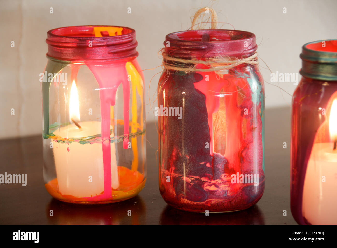 Photograph of some colorful cristal lamps with a wax candle inside ...