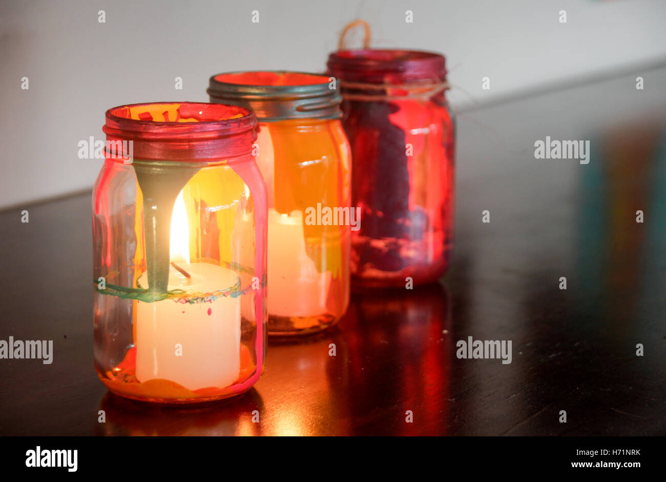 Photograph of some colorful cristal lamps with a wax candle inside ...