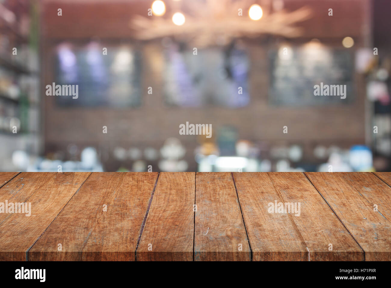Brown wooden table top with blurred cafe. product display template ...