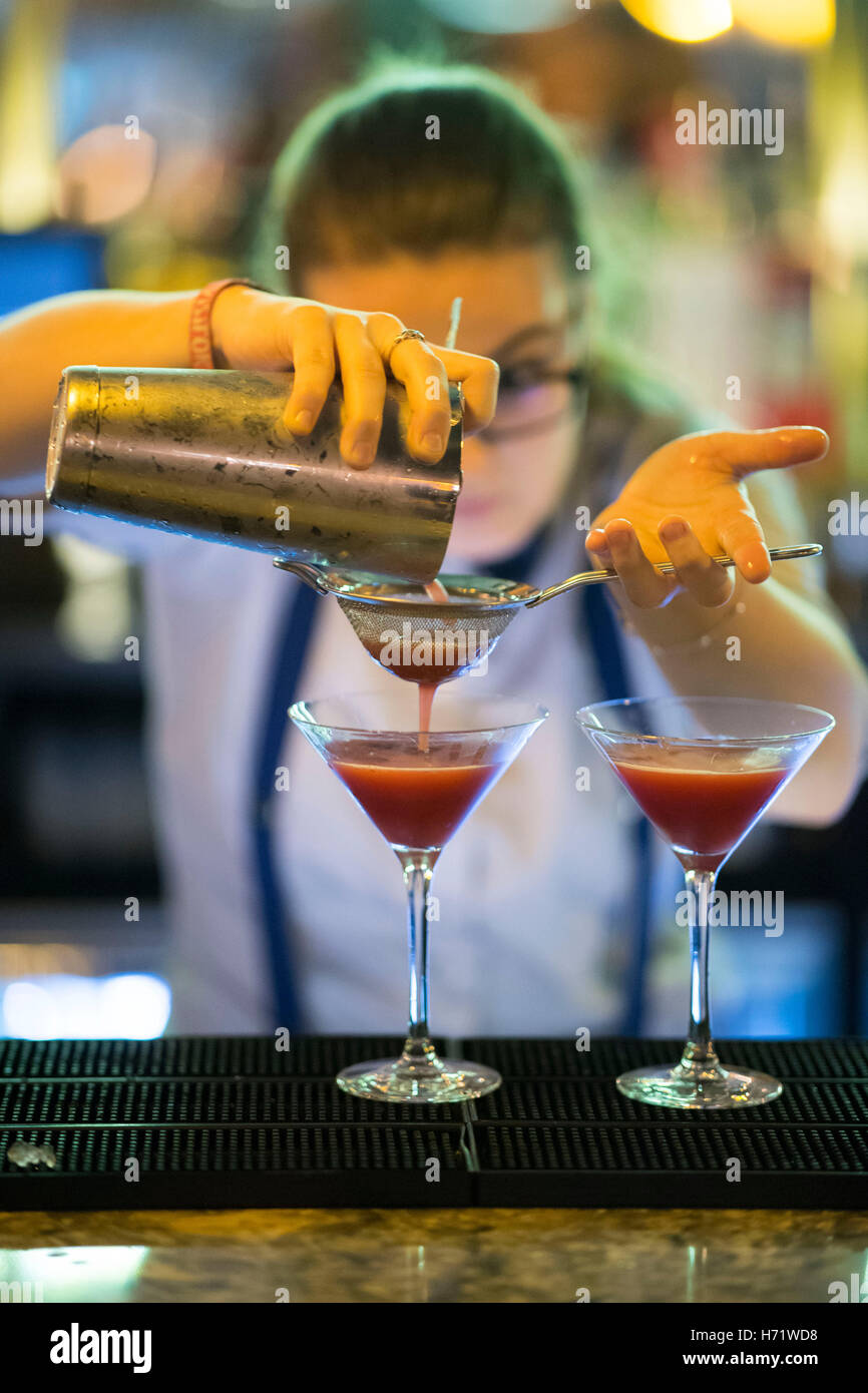 A woman makes cocktails at a bar Stock Photo - Alamy