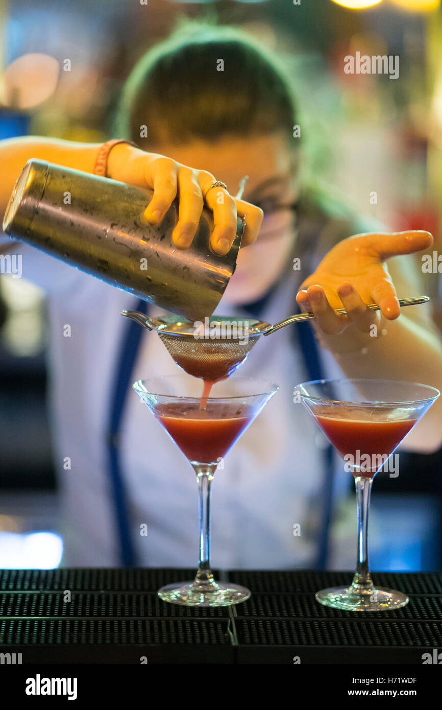 A woman makes cocktails at a bar Stock Photo - Alamy