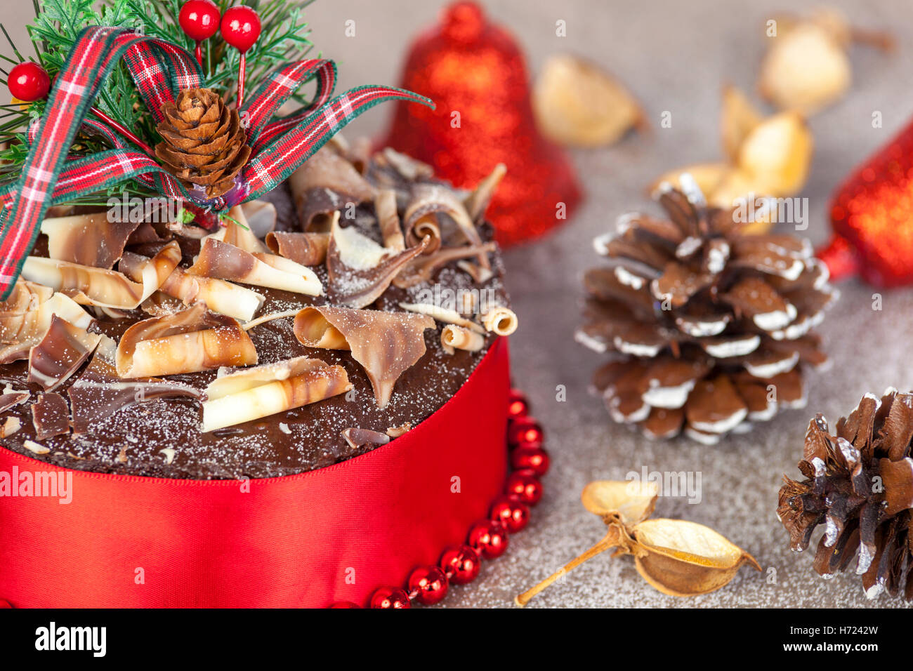 Chocolate christmas cake with twirl topping wrapped in a red ribbon ...